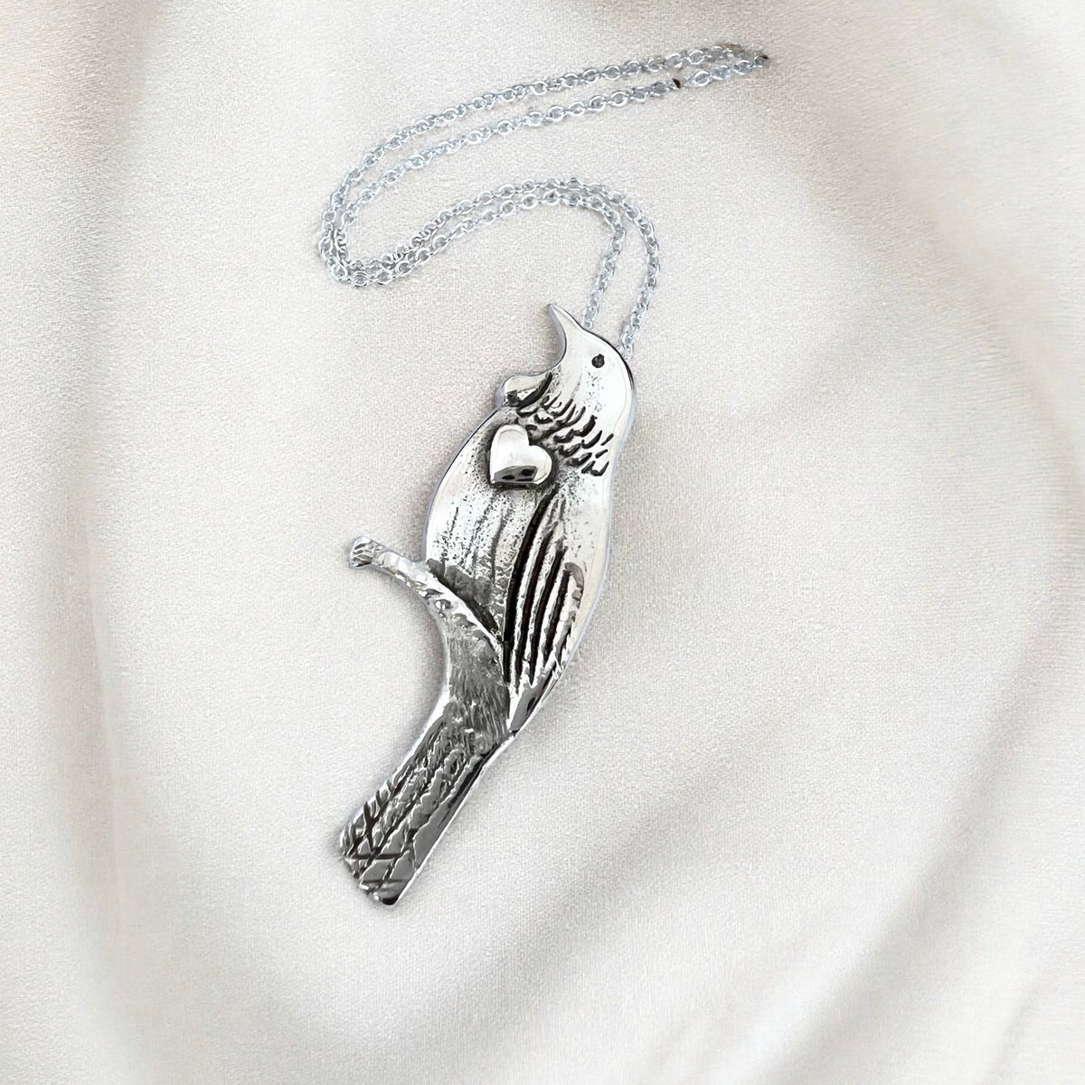 Handsome Tui with heart necklace, sterling silver – Tania Mallow Jewellery
